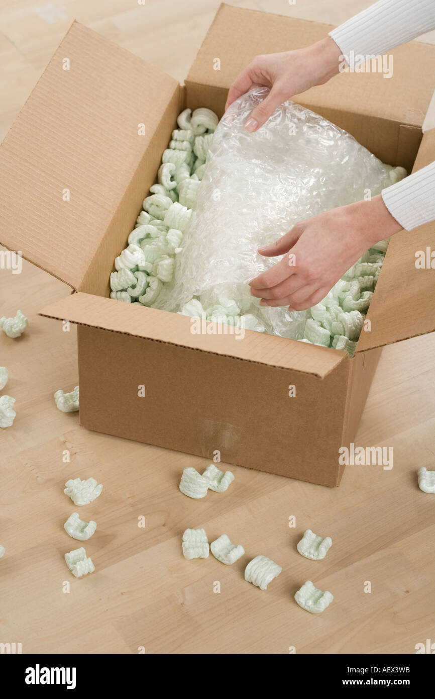 Woman unpacking a box Stock Photo - Alamy