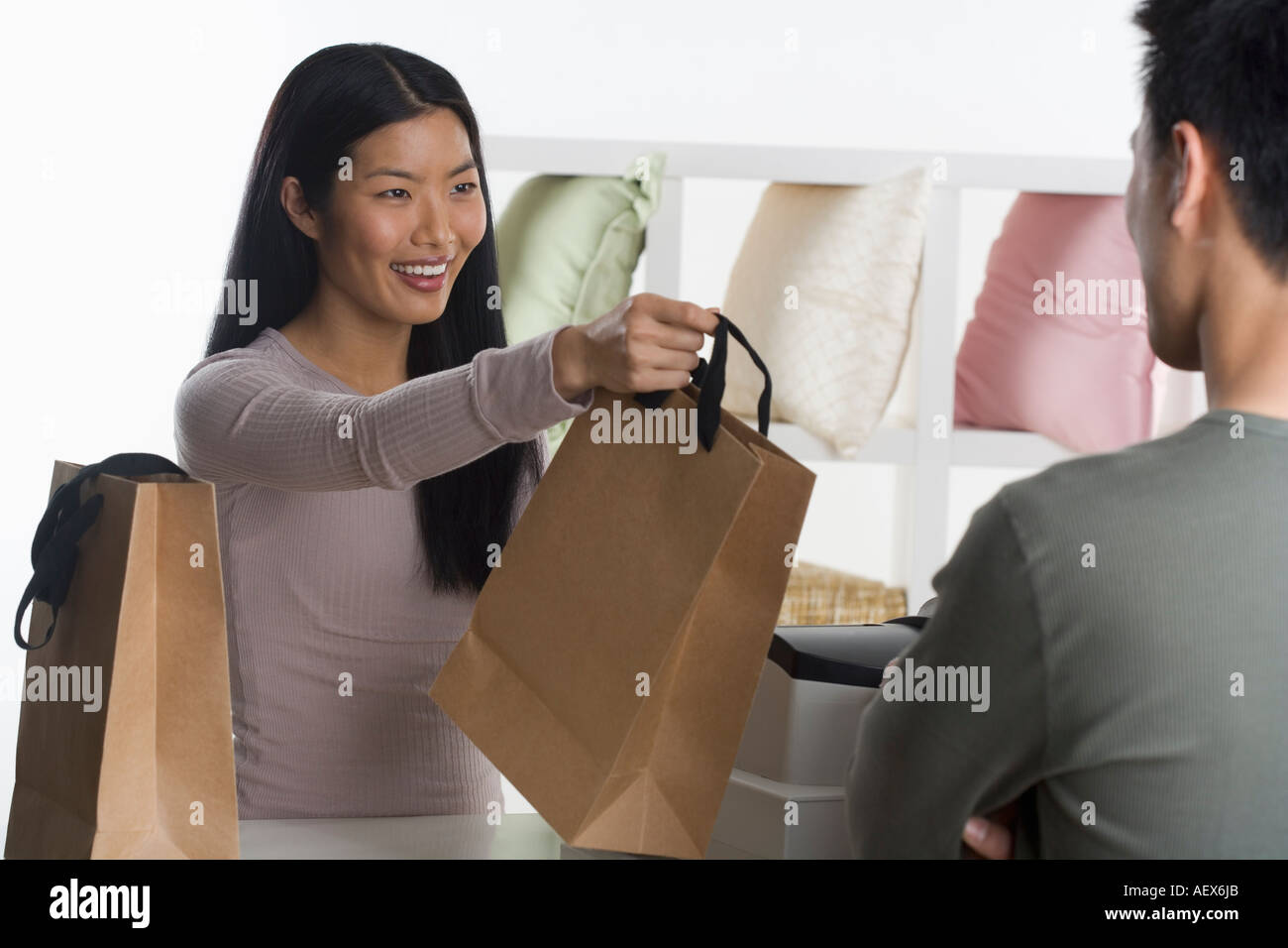 Female sales person assisting customer Stock Photo - Alamy