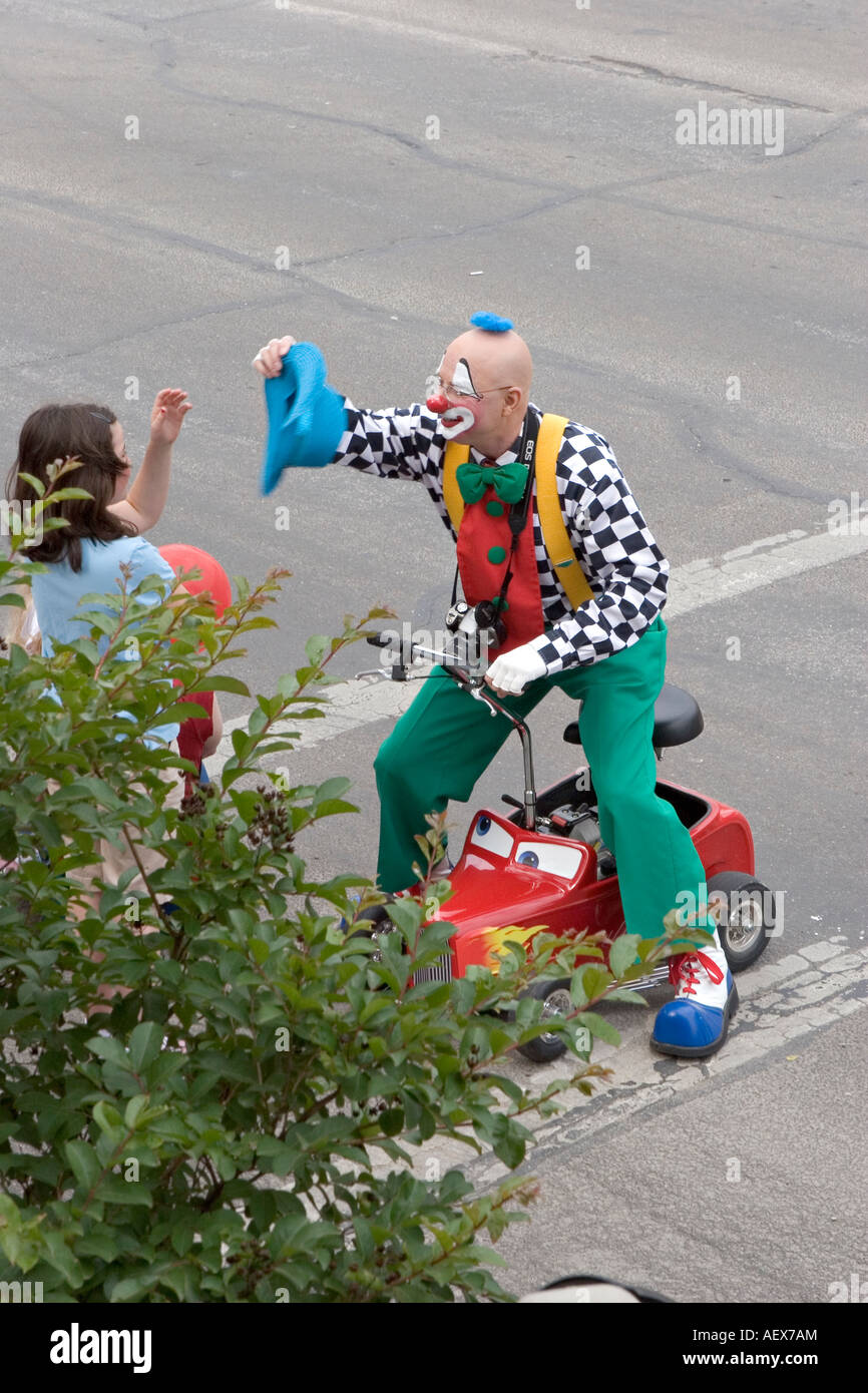 Clown entertaining curbside crowd at street festival parade Stock Photo ...