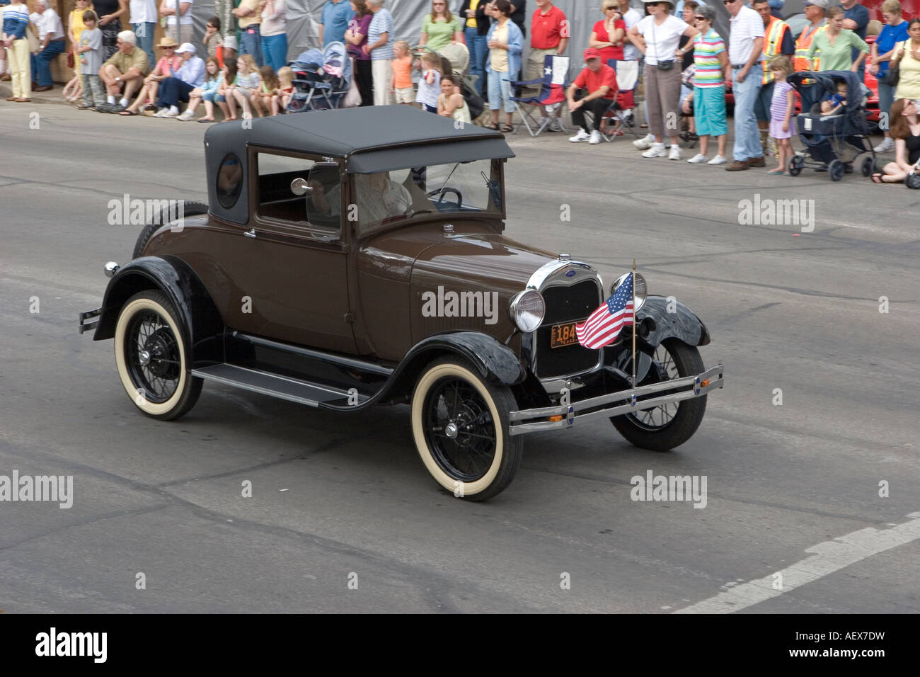 Brown Ford Model A driving in street festival parade Stock Photo - Alamy