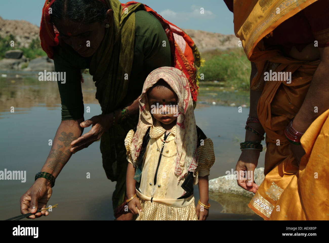 A young girl gets the Hindu equivalent of a western christian baptism ...