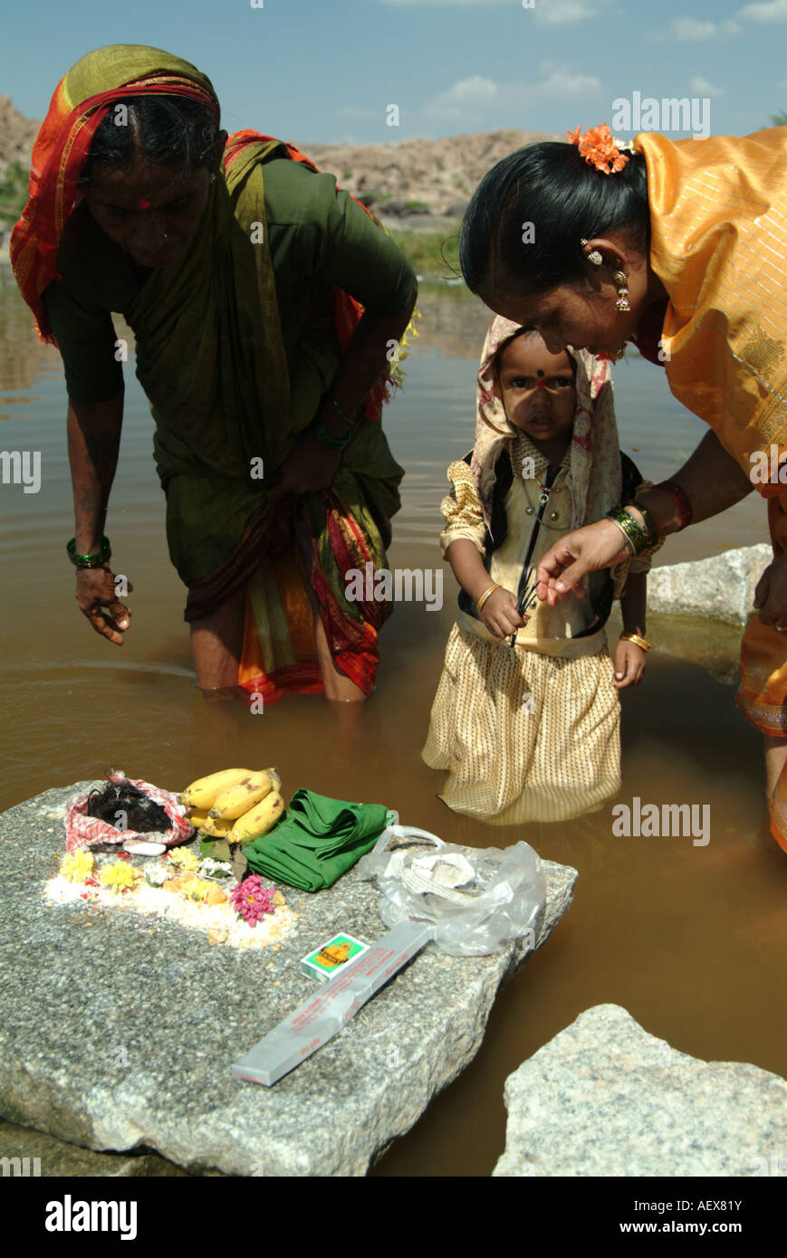 A young girl gets the Hindu equivalent of a western christian baptism ...