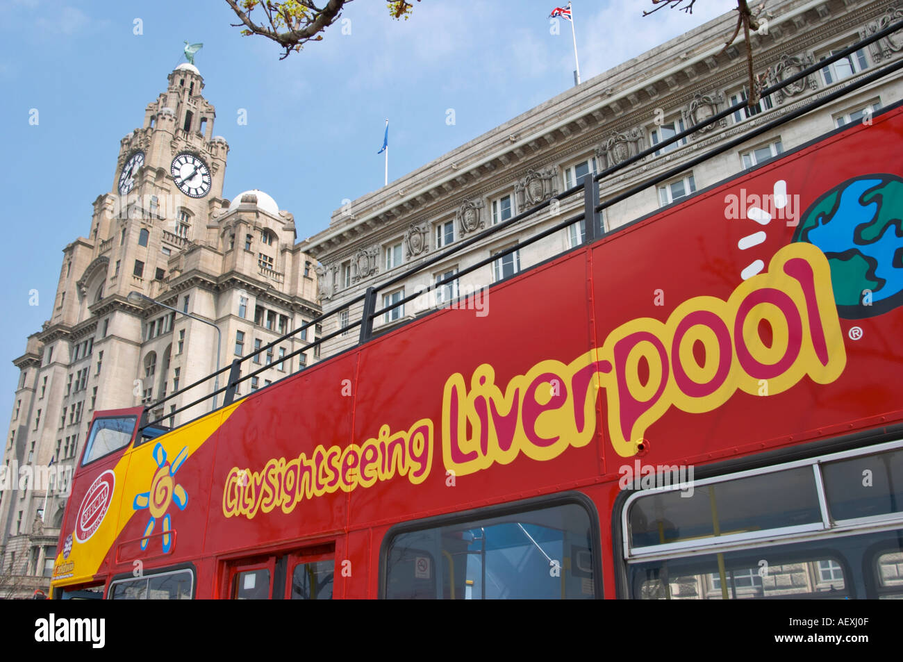A sightseeing bus in front of the Liver building Liverpool Stock Photo ...
