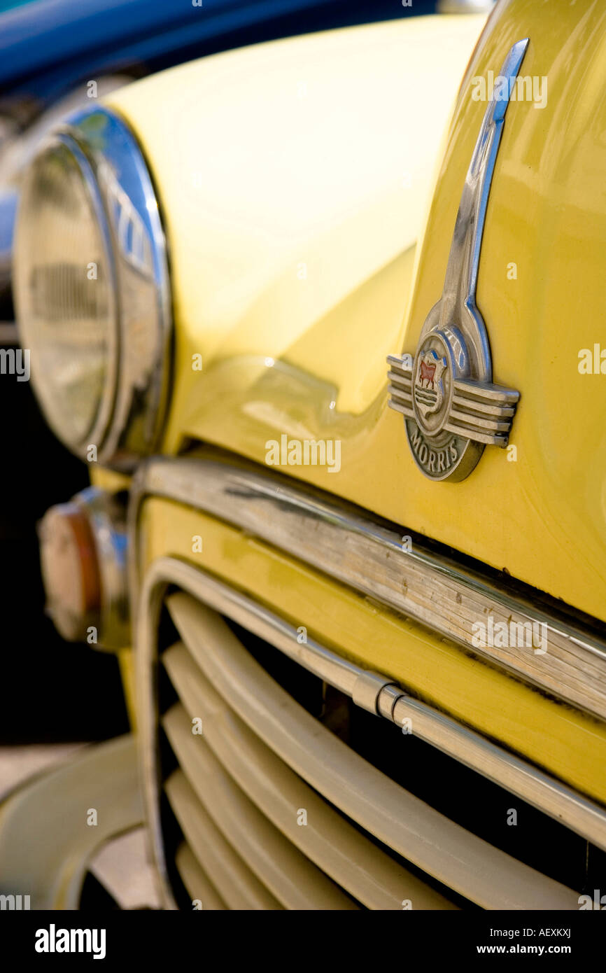 A close up of the front of a bright yellow vintage Morris Minor car in ...