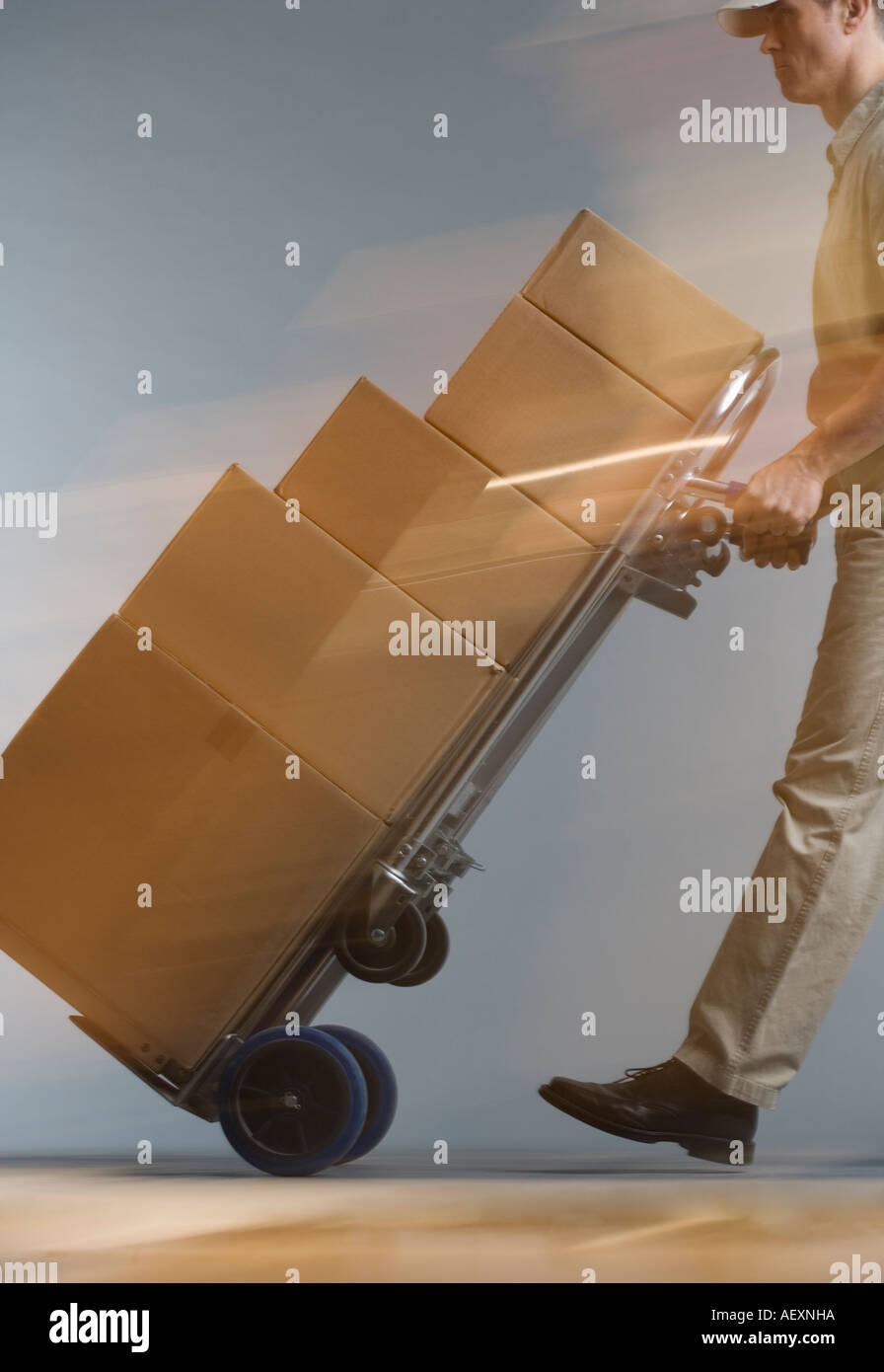 Delivery man with packages Stock Photo - Alamy