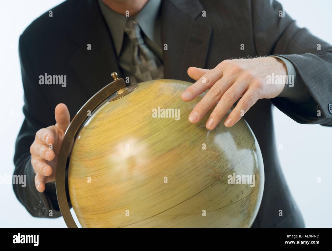 Man spinning a globe Stock Photo - Alamy