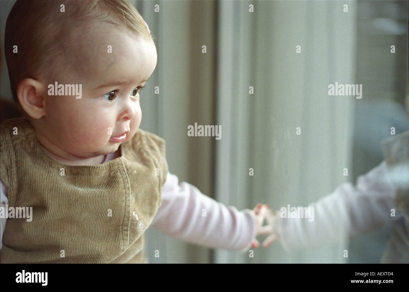 baby looking out of window Stock Photo - Alamy