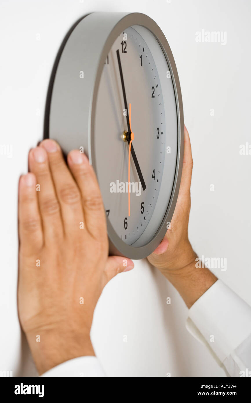 Man hanging on clock hi-res stock photography and images - Alamy
