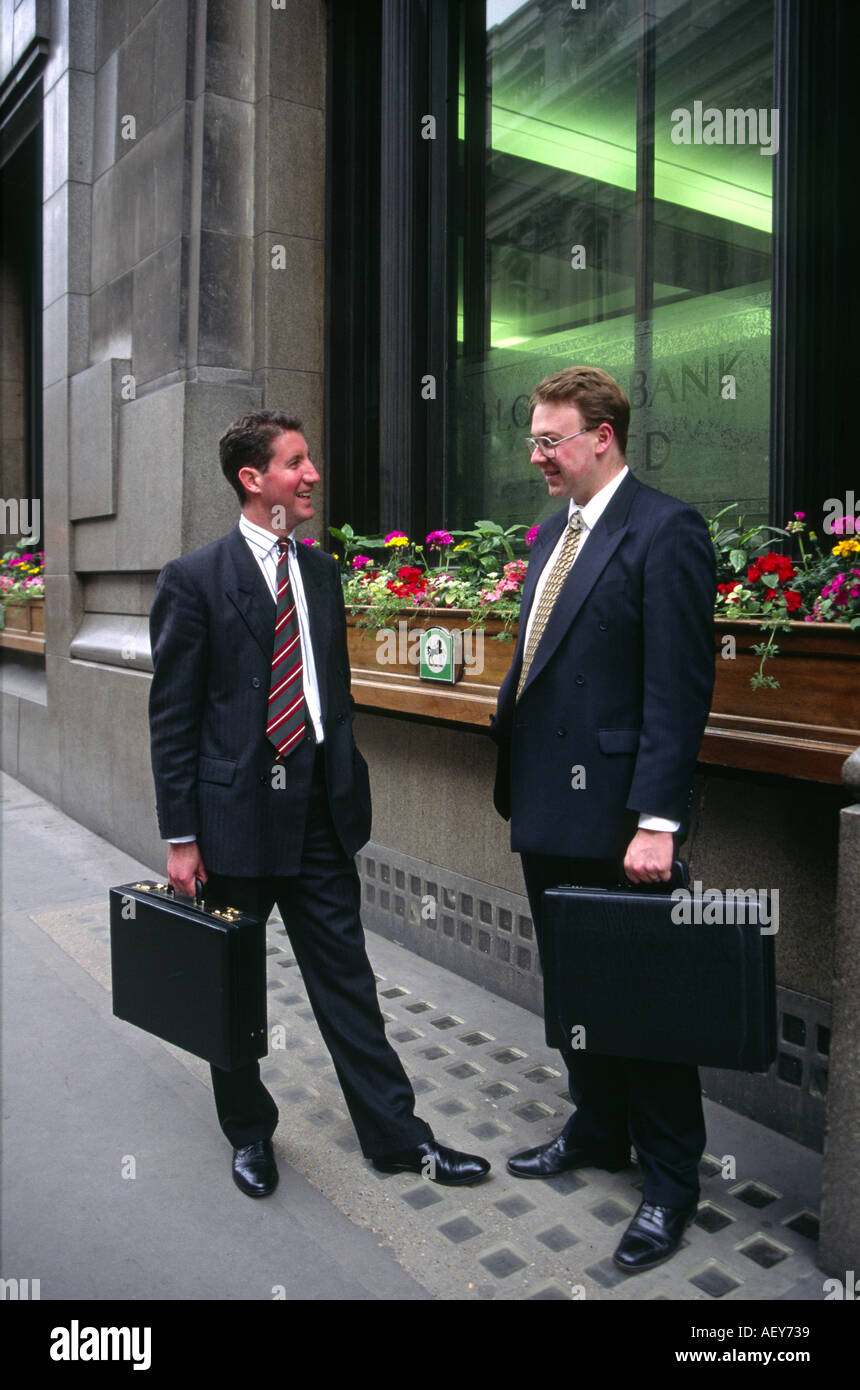Two businessmen talking City of London England Stock Photo - Alamy