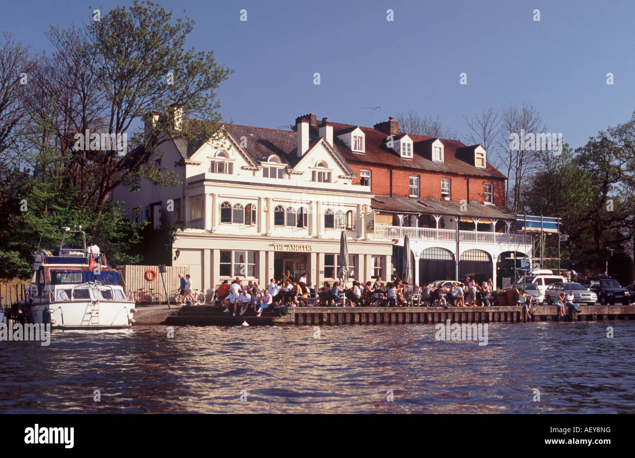 People sitting and drinking outside The Anglers riverside pub and ...