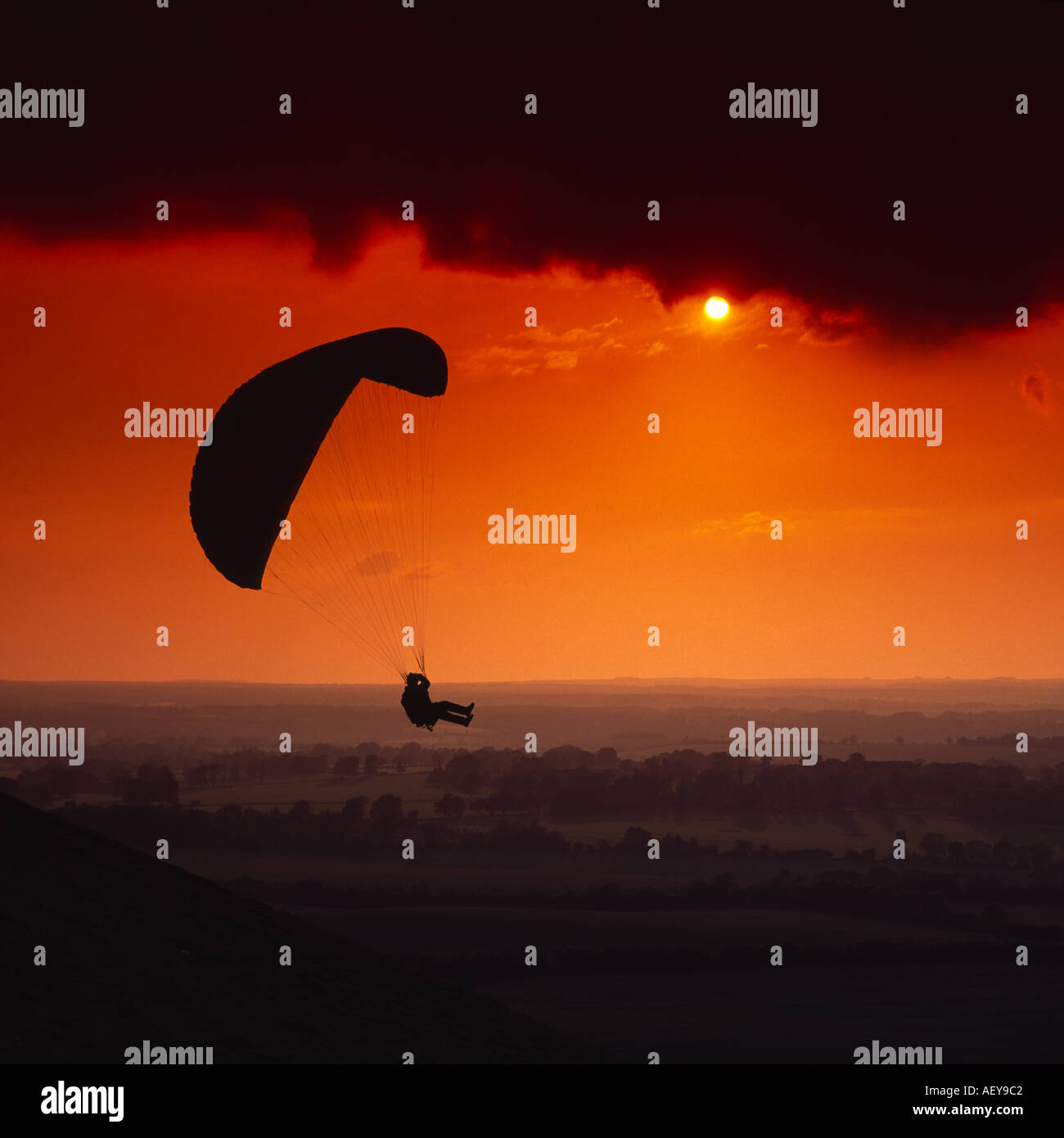 Paraglider flying against sunset Stock Photo - Alamy