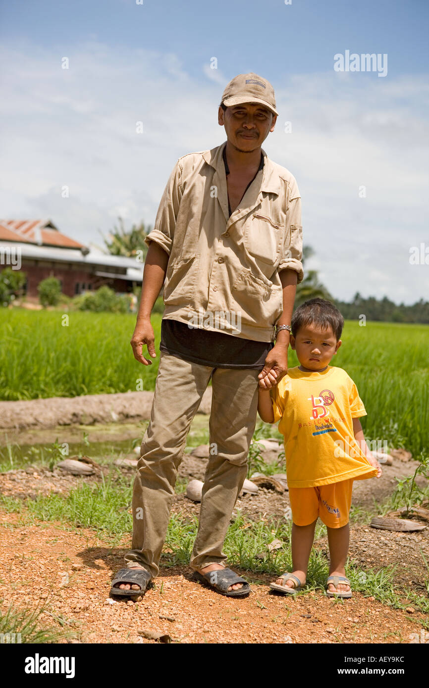 Malay farmer and his son nearby his kampung in Sekinchan, Malaysia ...