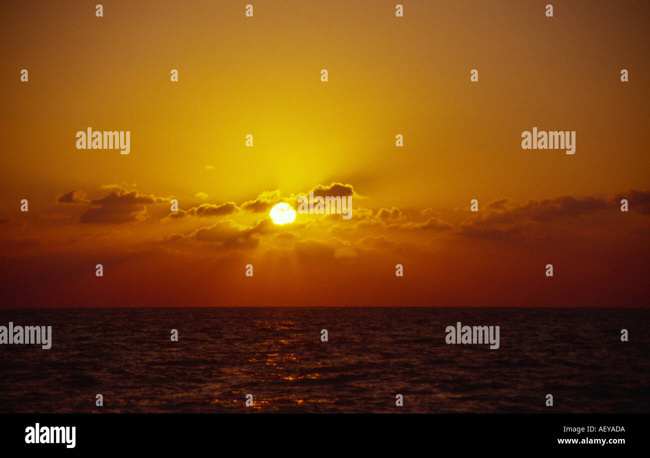 Yellow sun setting on the sea Stock Photo - Alamy