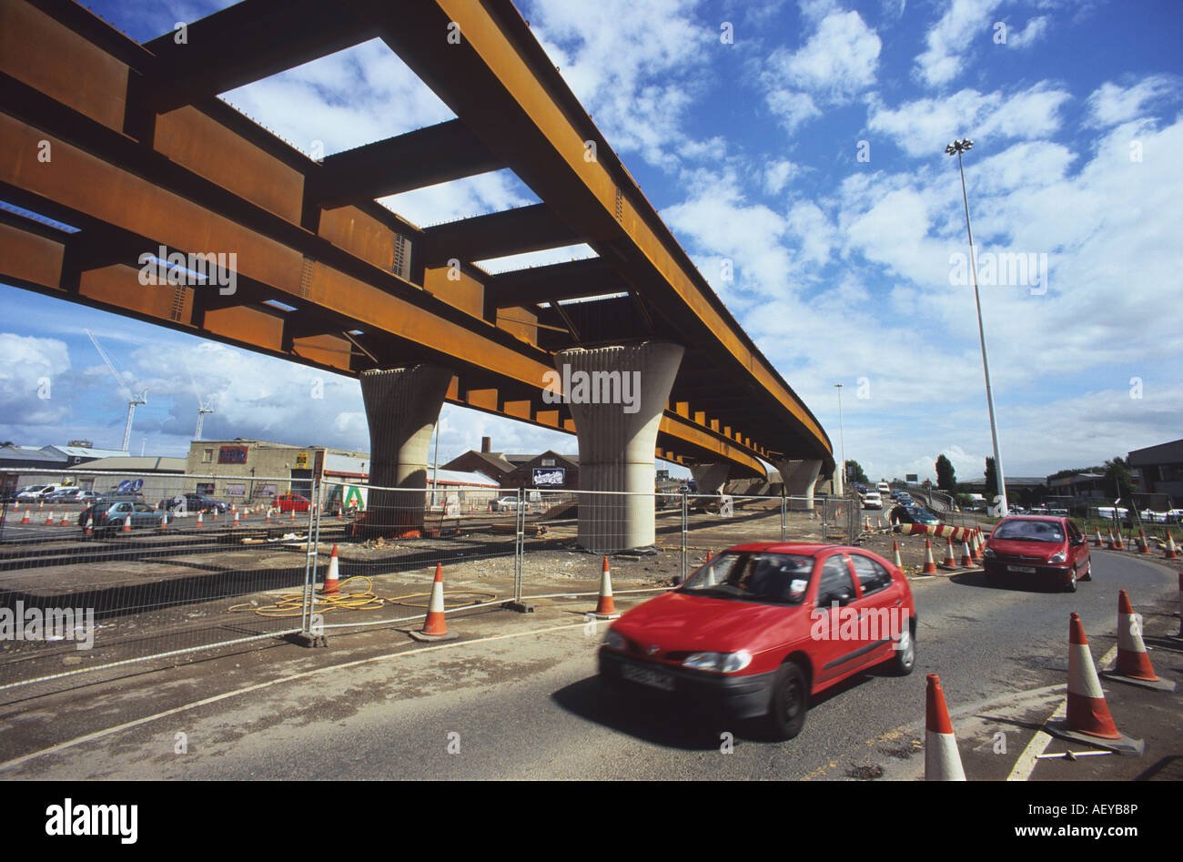 car travelling under construction work for new flyover road bridge ...