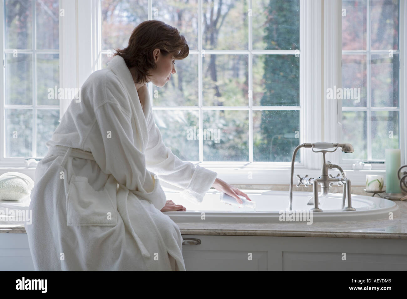 Woman in robe drawing bath hi-res stock photography and images - Alamy