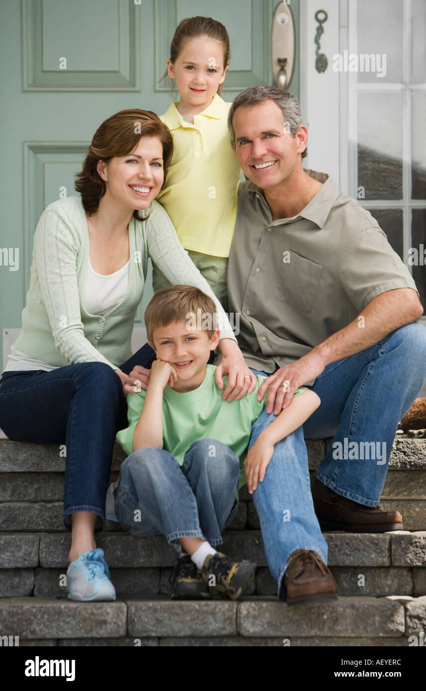 Family sitting on front steps Stock Photo - Alamy