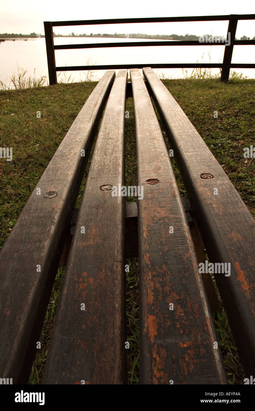 Wooden park bench and railing in Paya Indah Wetlands, Malaysia Stock ...