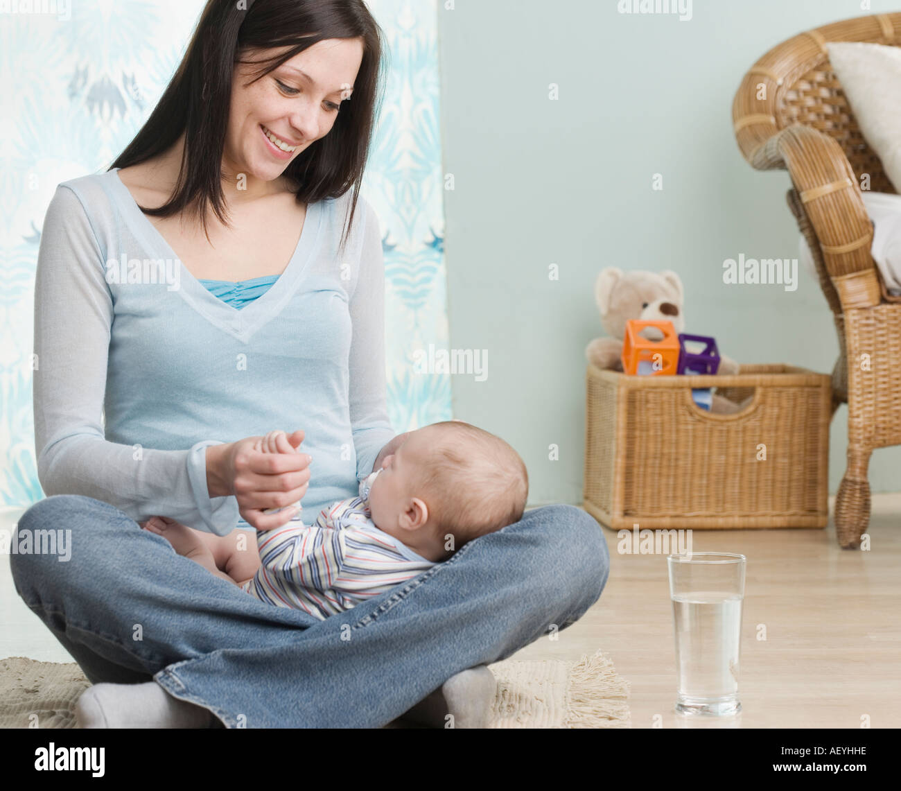 Mother holding baby on her lap Stock Photo - Alamy
