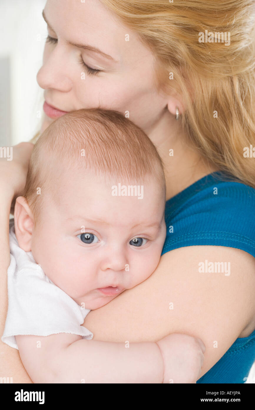 Mother hugging baby Stock Photo - Alamy