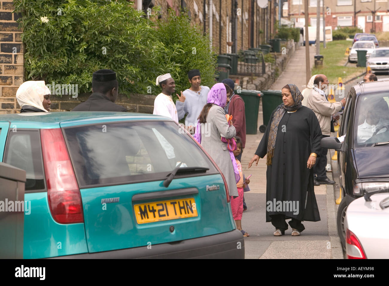 Muslims outside a mosque in bradford wearing a mix of traditional and ...