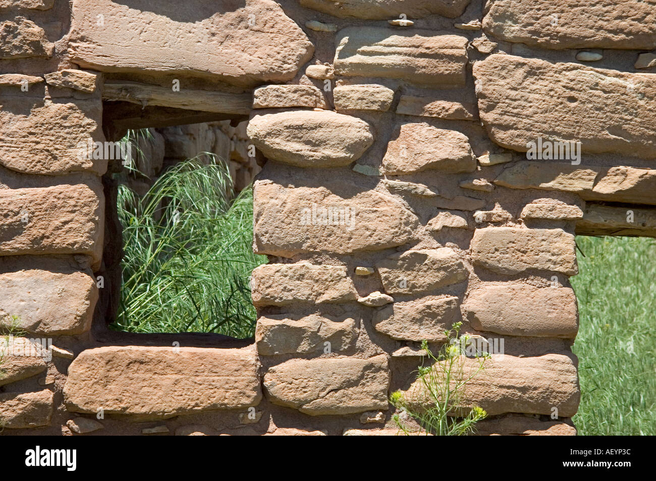 looking through an indian ruin window into the room inside tight ...