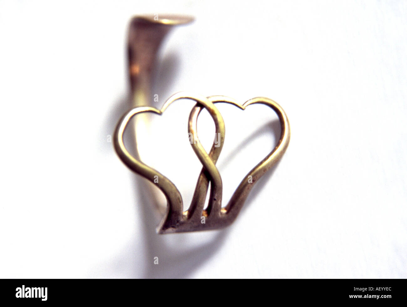 fork bent as two hearts interlaced Stock Photo - Alamy