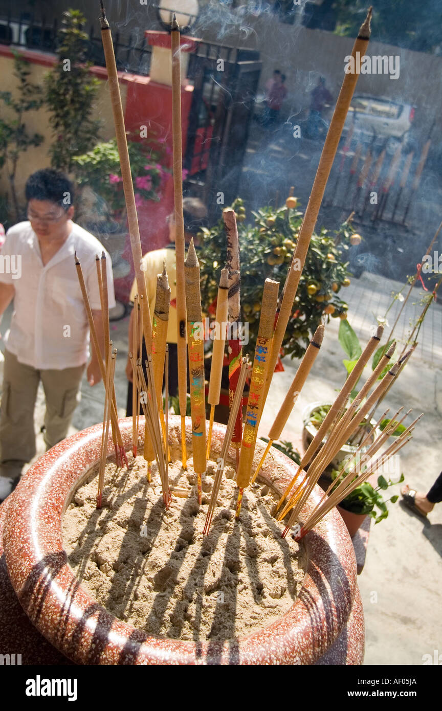 Incense placed at a praying pot in a chinese temple during the Chinese ...