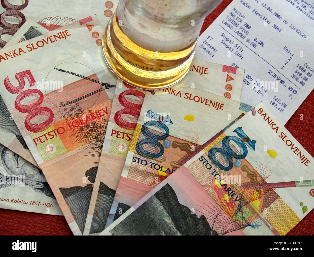 money from Slovenia Tollar on a table of a restaurant with a receipt ...