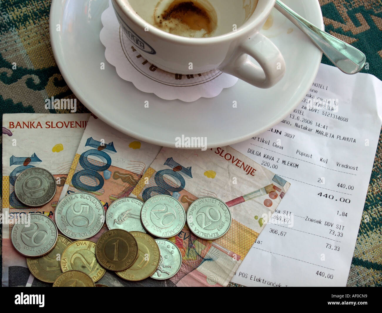 money from Slovenia Tollar on a table of a café with a receipt and ...