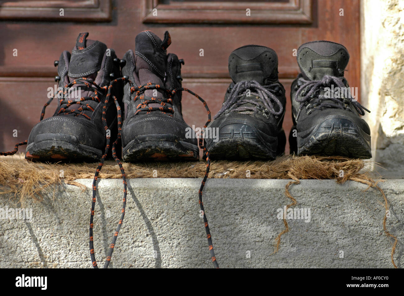 two pairs of walking shoes on stairs in front of entrance door Stock ...