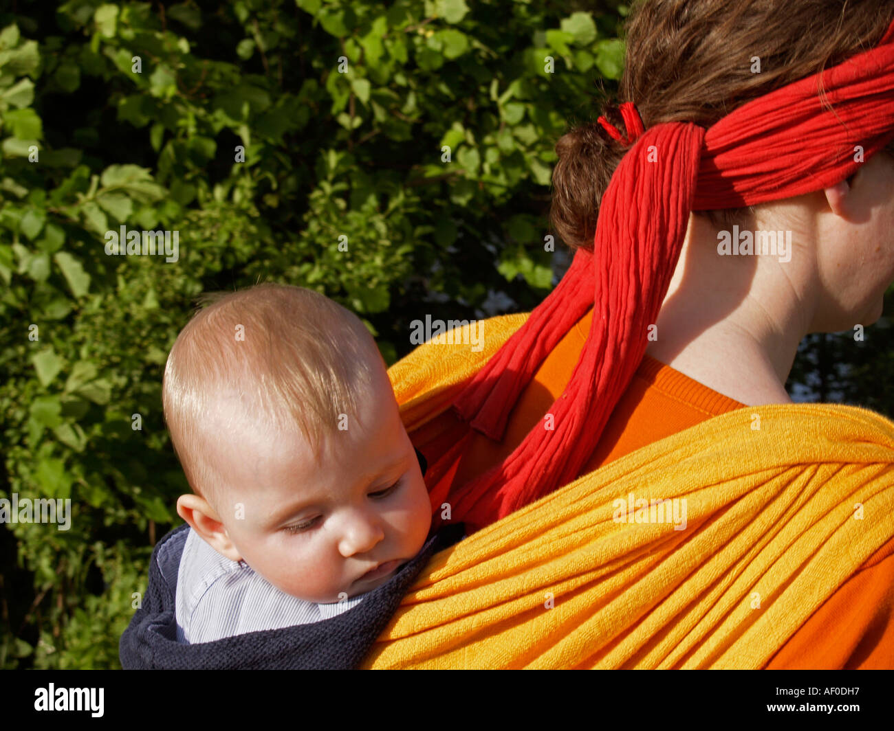 Mother carry child back sling hi-res stock photography and images - Alamy