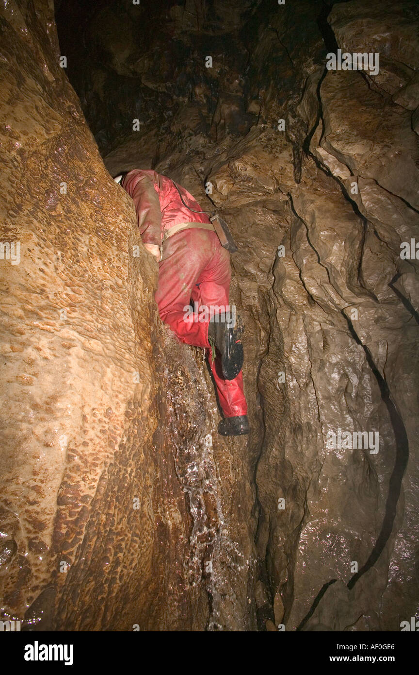 a male caver climbs a waterfall pitch in the newly discovered Notts II ...