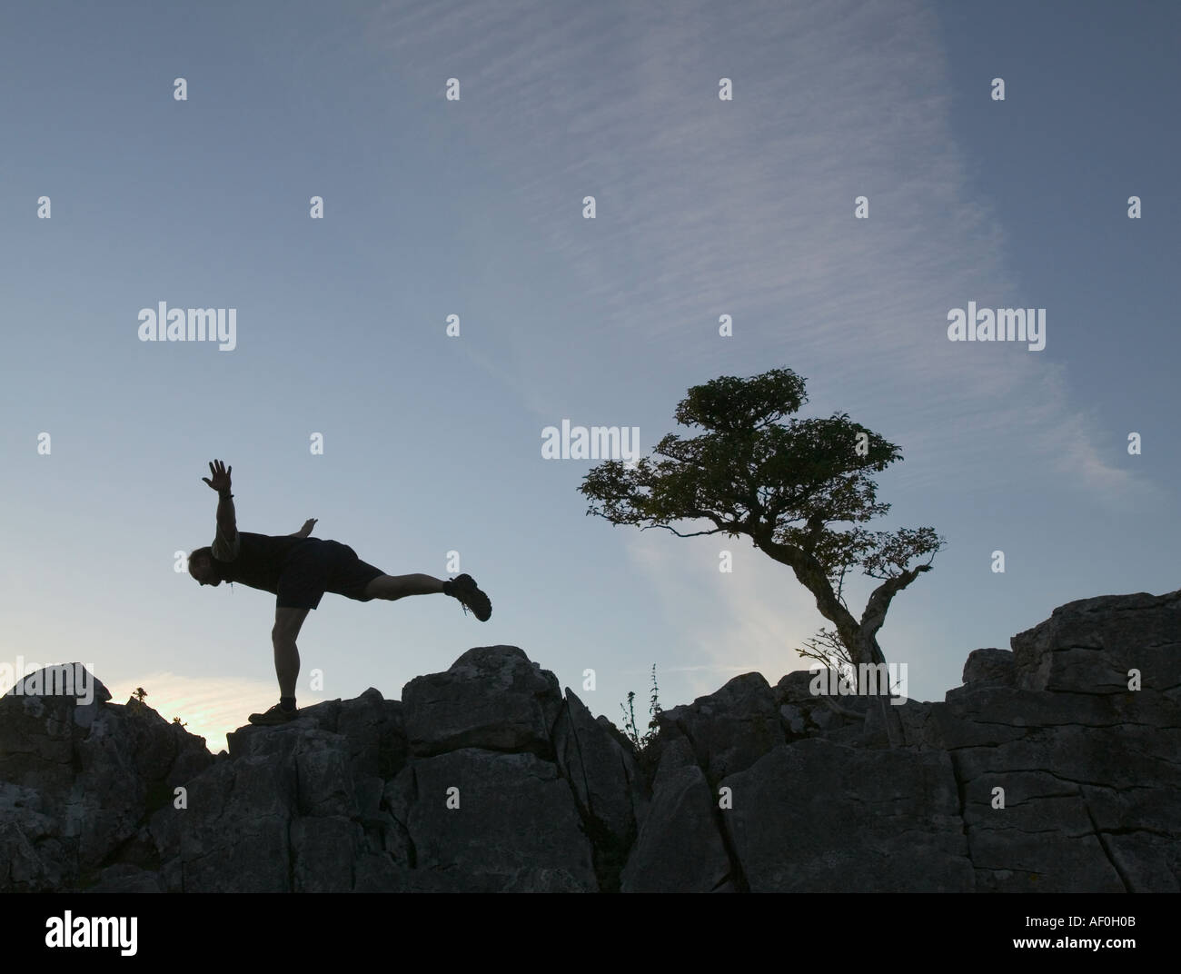 a man performs aerobic tai chi type exercise on limestone pavement on ...