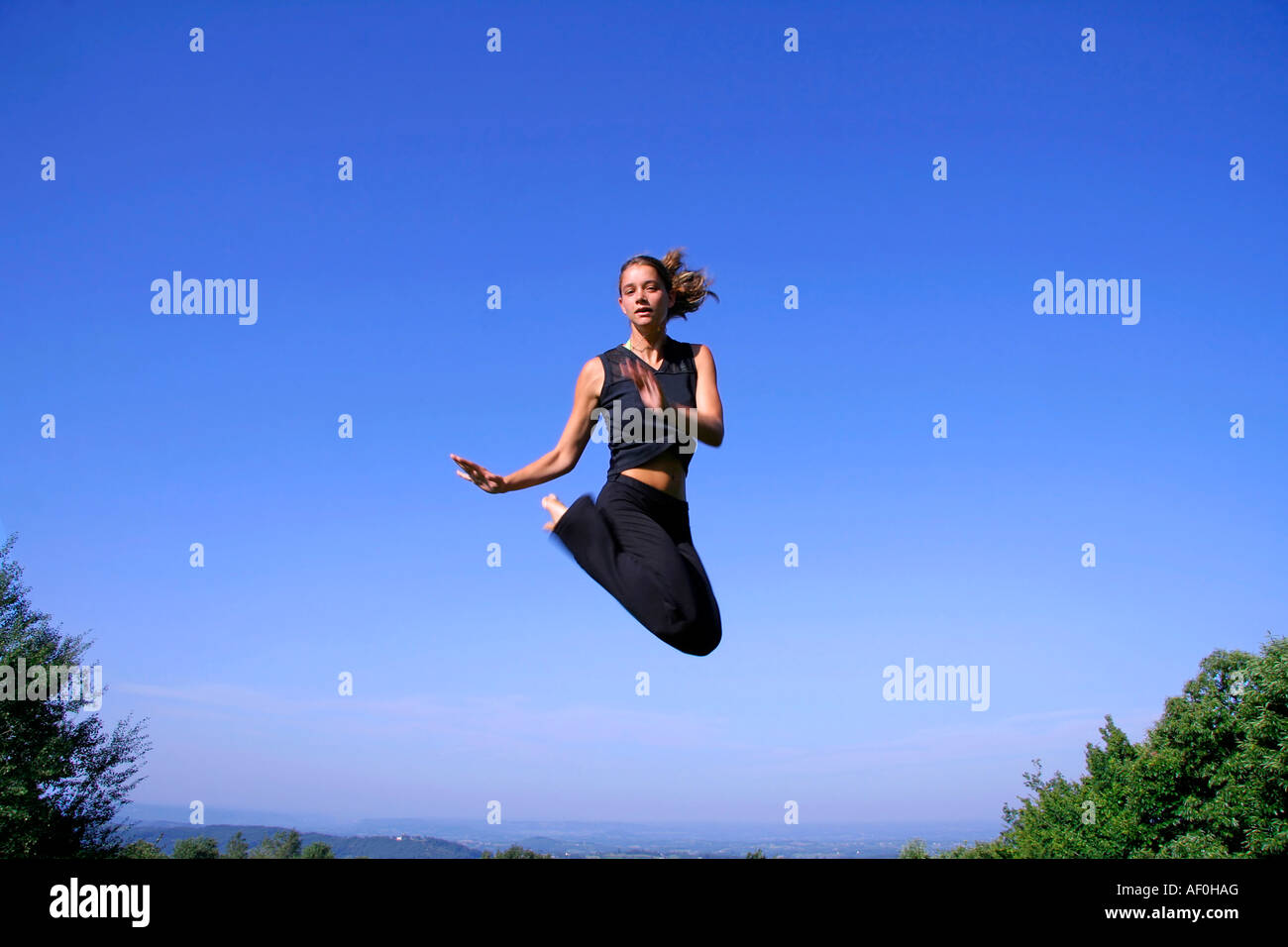 healthy young woman jumping with joy Stock Photo - Alamy
