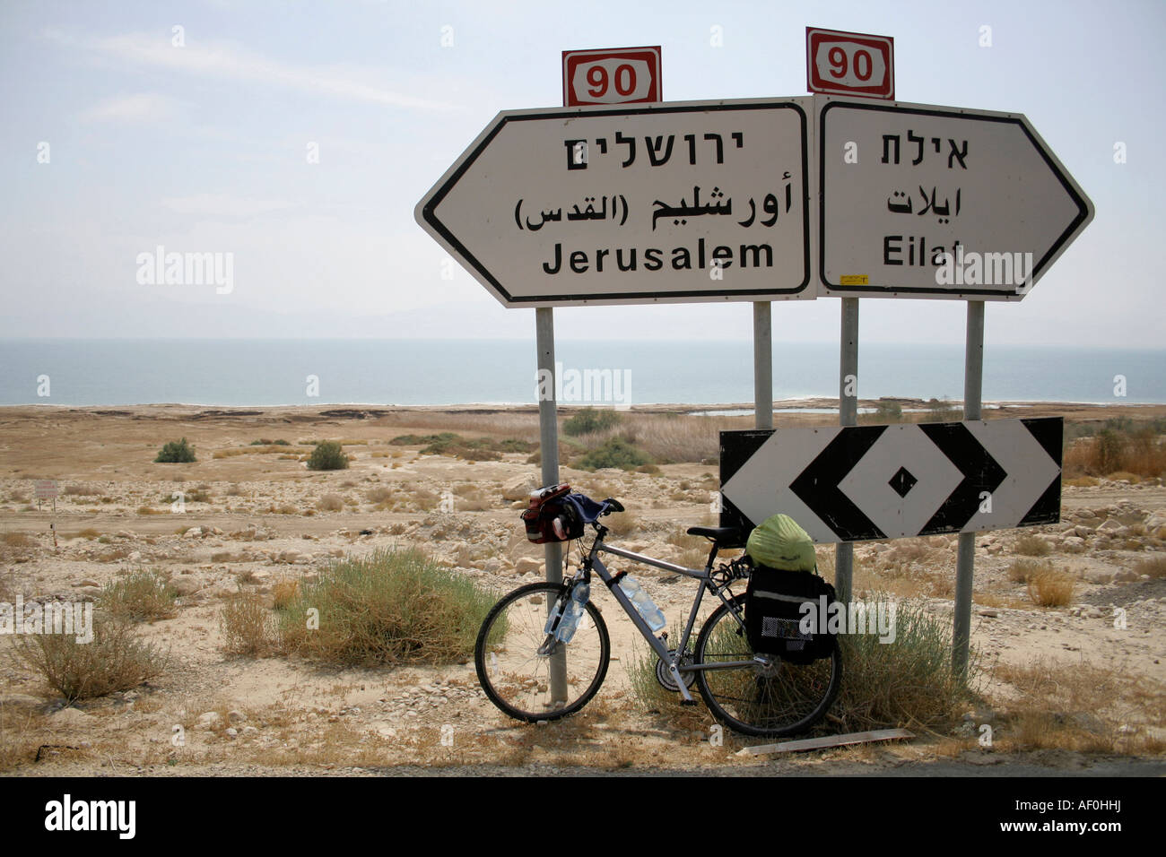 bicycle parked against the jerusalem and eilat road signs Stock Photo ...