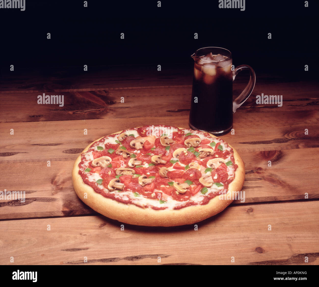 Whole Pepperoni Pizza with Glass of Soda Stock Photo - Alamy