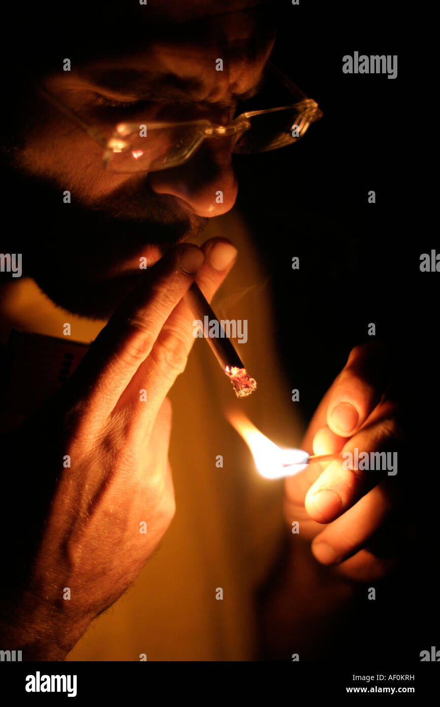 man smoking cigarette in the dark Stock Photo - Alamy