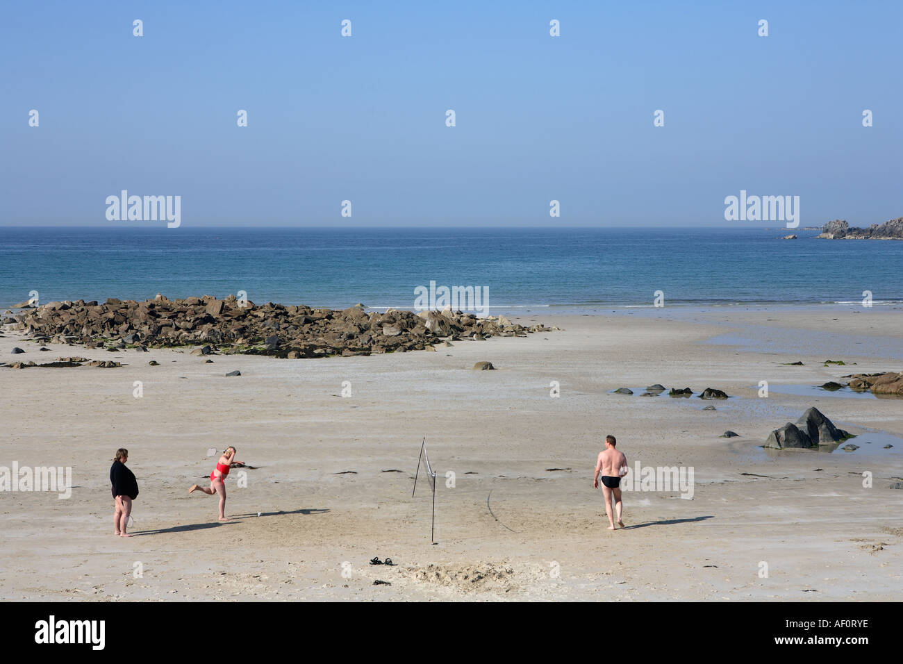 Fat people playing badminton on the beach Guernsey Channel Islands U K ...