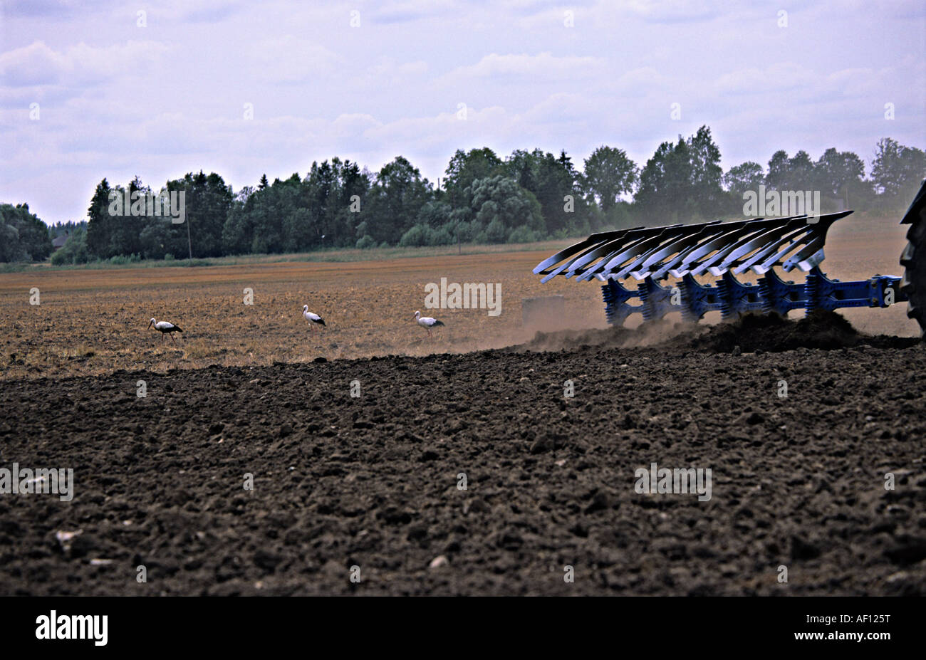 Agricultural machinery ploughing Stock Photo - Alamy