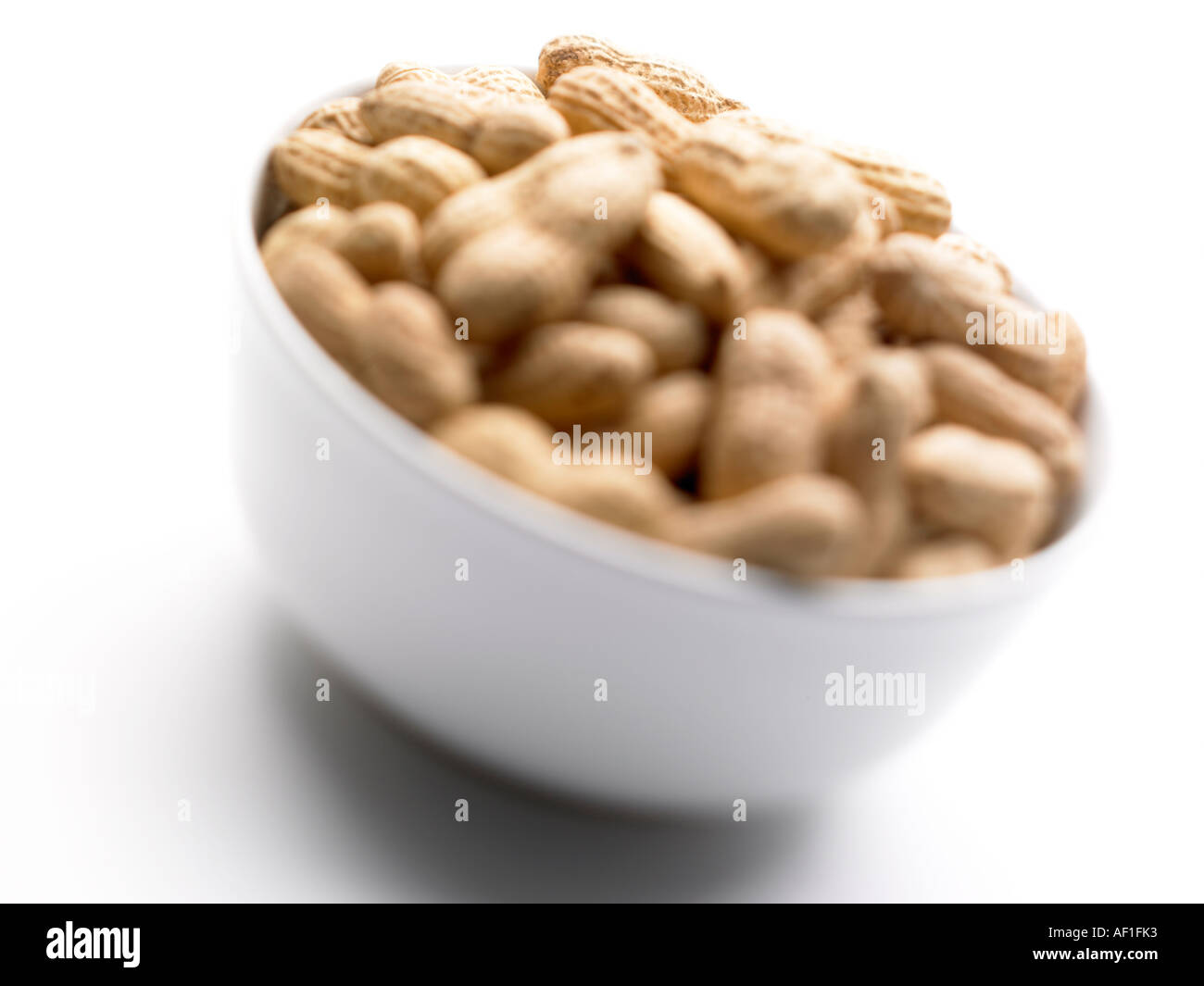 Landscape shot of peanuts in white bowl on white background Stock Photo ...