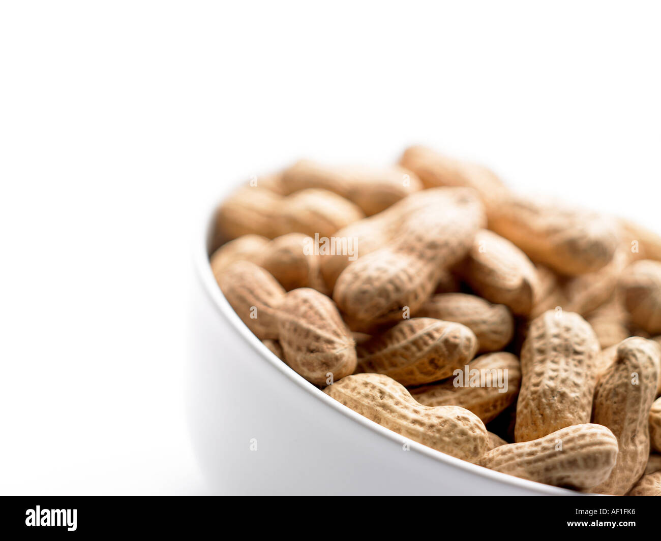 Landscape shot of peanuts in white bowl on white background Stock Photo ...