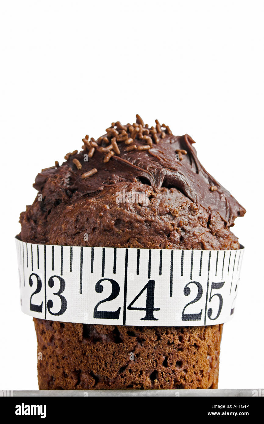 Vertical colour picture of a chocolate cake with a measuring tape ...