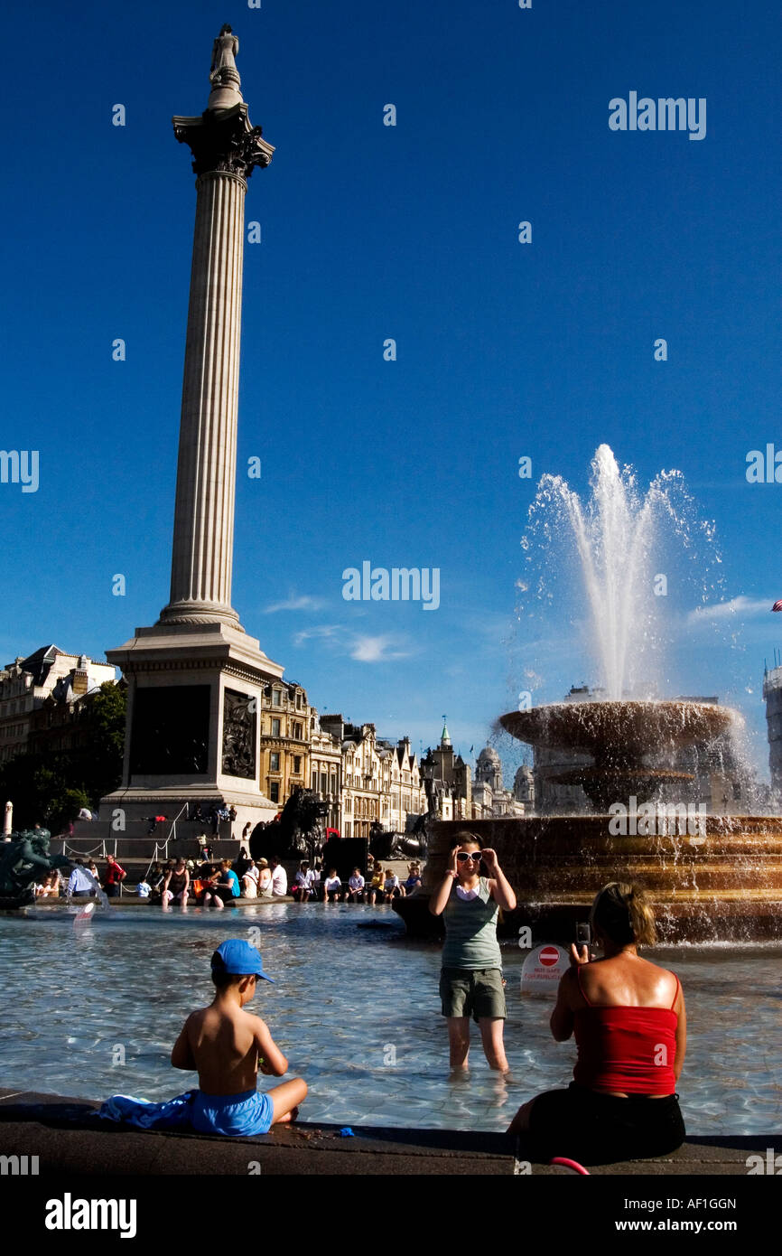 A family enjoys the summer sun while cooling of in the fountains around ...