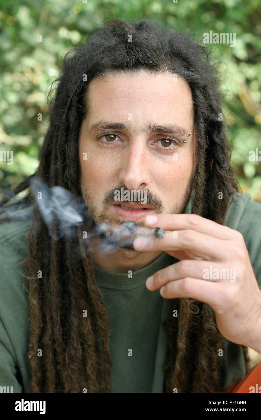 hippy preparing rolling and smoking marijuana joint photos series Stock ...
