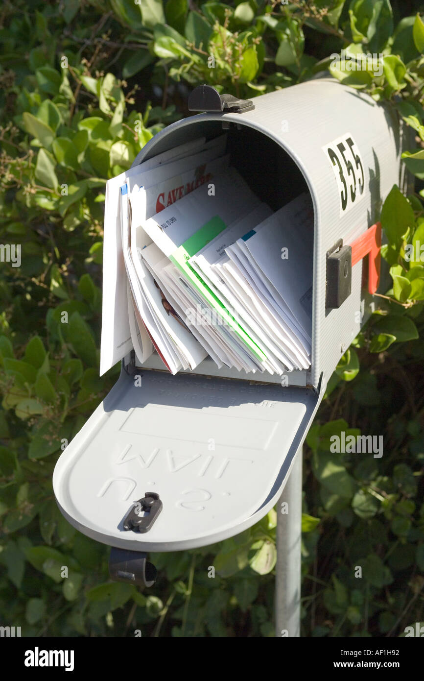 Mail box full of bills Stock Photo - Alamy