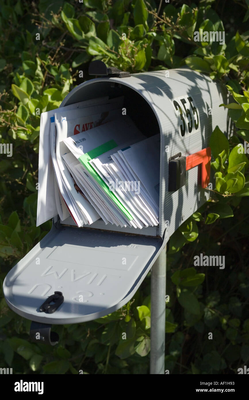 Mail box full of bills Stock Photo - Alamy