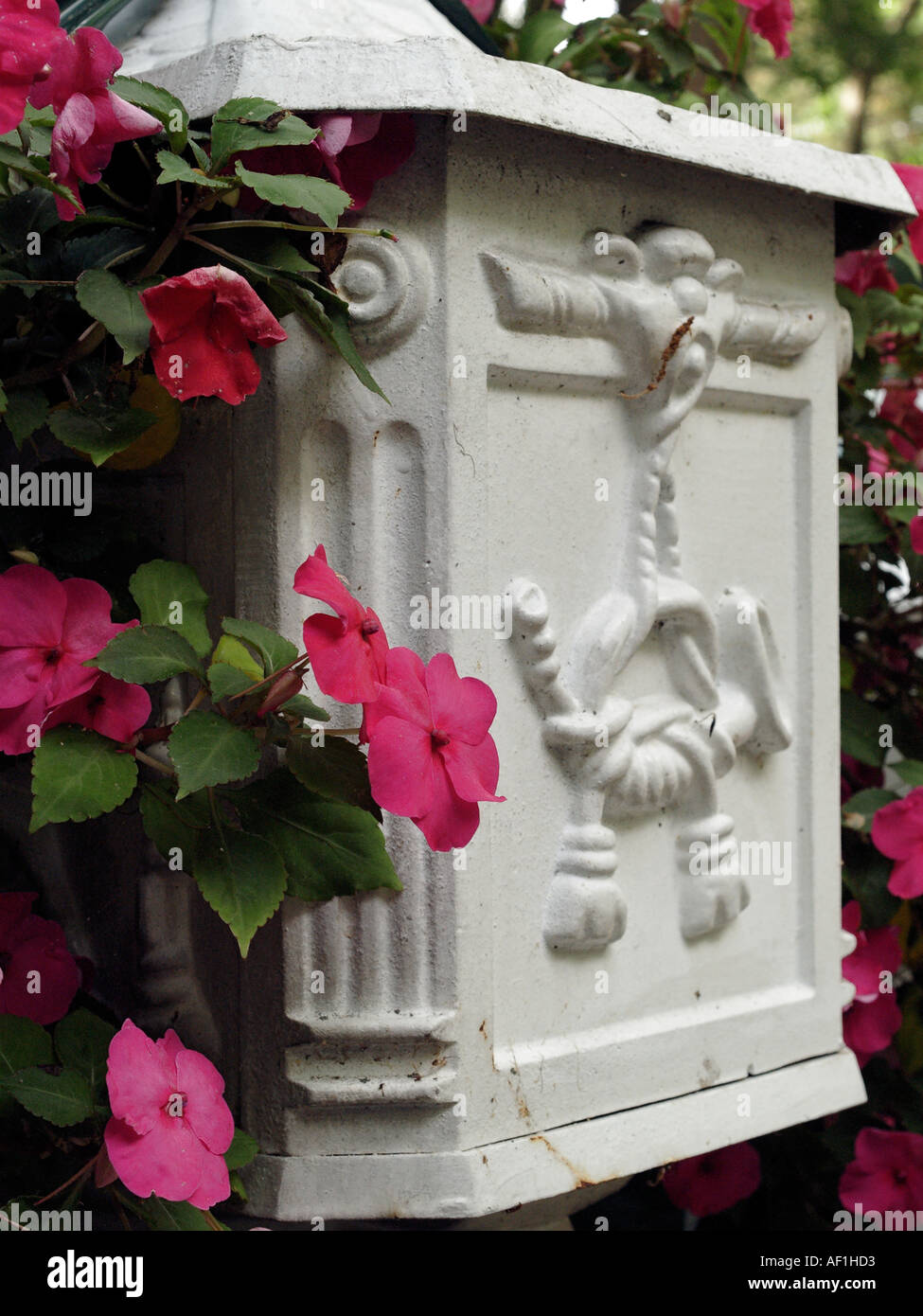 An antique post box used as a garden planter Stock Photo - Alamy