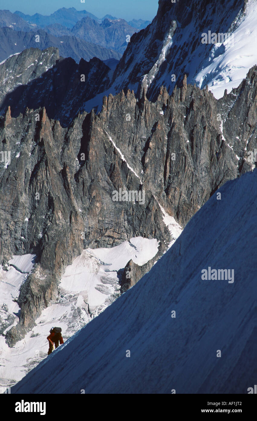 A climber ascending a ridge high in the French Alps with les Periades ...
