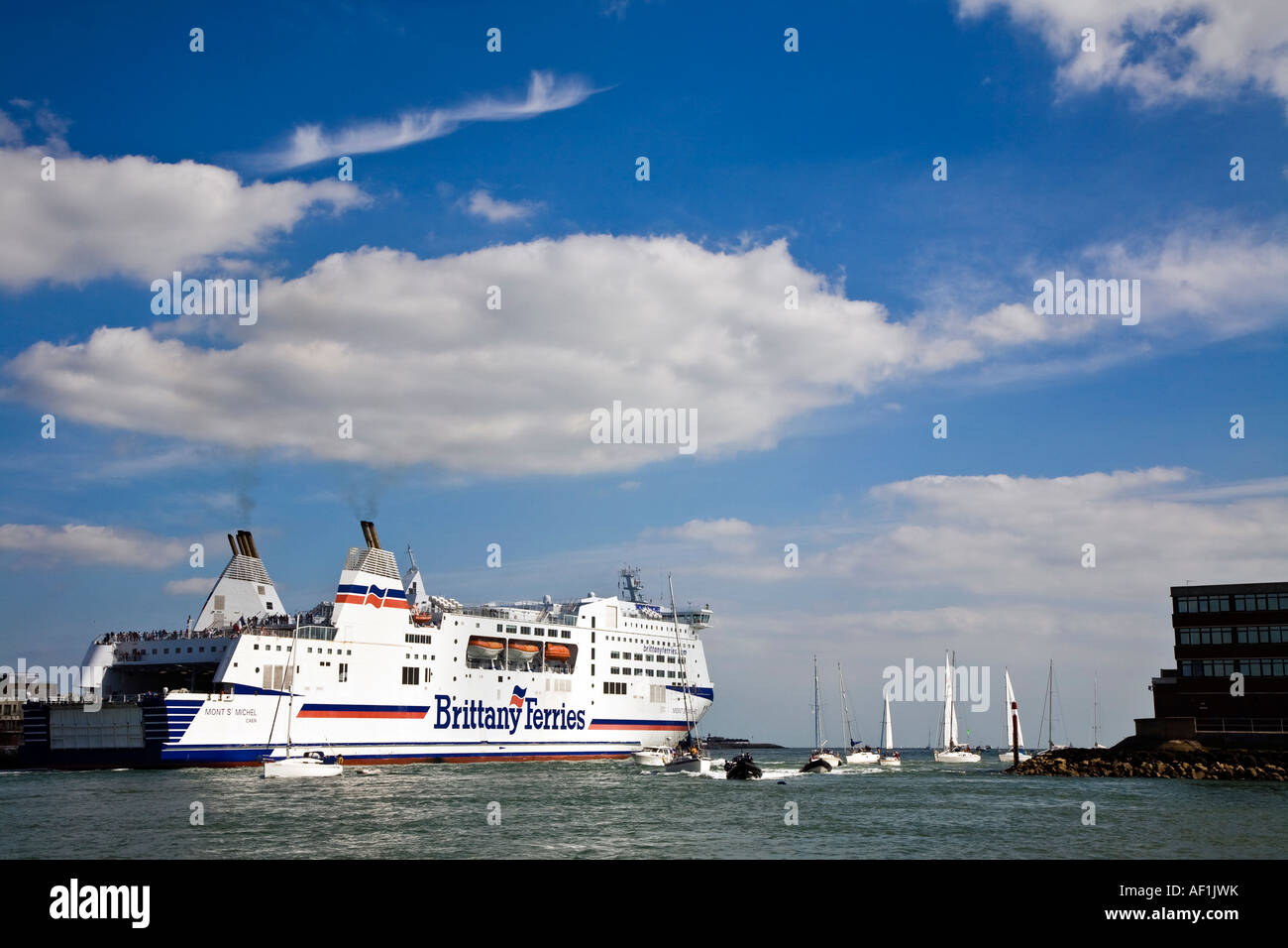 Large car ferry passing yachts at the narrow entrance to Portsmouth ...