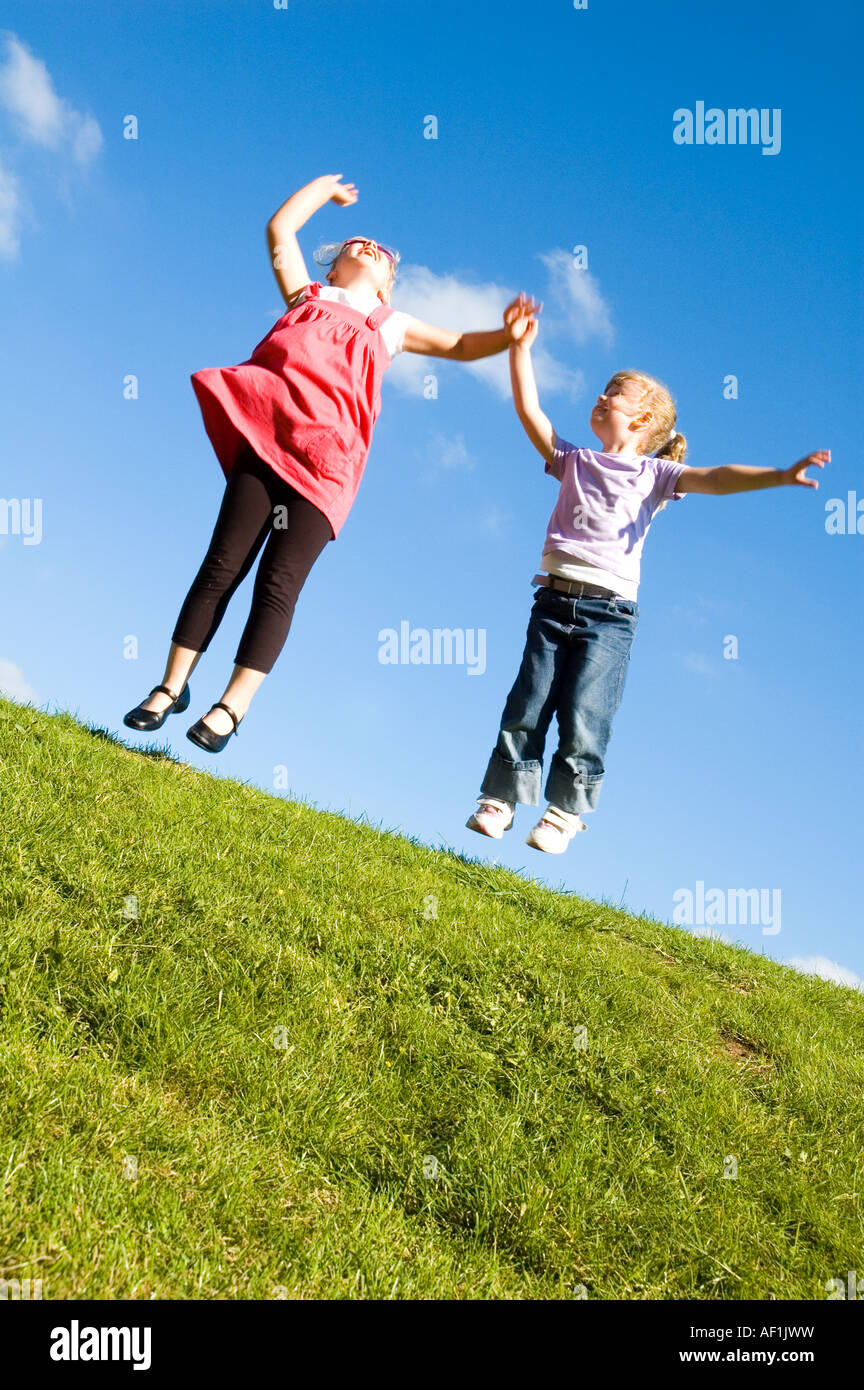 Two Girls Jumping Stock Photo - Alamy